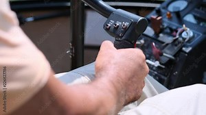 Male hand controlled helicopter, close up. The helicopter pilot holding a hand from the steering wheel of the helicopter. Controls a helicopter in the air