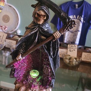 Don't Fear the Reaper. Add a dash of gothic flair to your abode with our glowing grim reaper backflow incense burner, ideal for conjuring a hauntingly chic atmosphere this Samhain or Halloween. By the way, we've shuffled a treasure trove of goodies between our stores, including the enigmatic Chiastolite, the serene Seraphinite, and an astonishing Bastet effigy, among a plethora of other wonders. Easy peezy. So, should you find yourself smitten with this diminutive specter and yearn for its prese