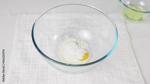 Pour a teaspoon of baking powder into a transparent bowl with eggs to prepare the dough. High quality 4k footage