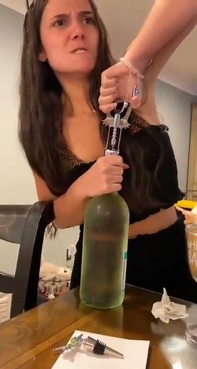Woman Struggles to Open Her Very First Wine Bottle Using Bottle Opener - 1355604