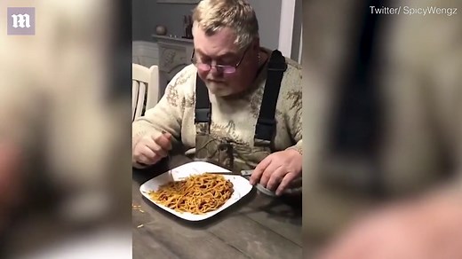 Ingenious moment man eats spaghetti with fork and scissors