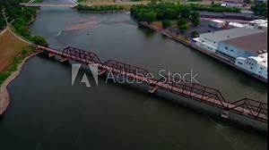 King Bridge Co. Bridge, The pedestrian bridge is a main thoroughfare for bicyclists and pedestrians seeking to pass over the Rock River for Rockford. Aerial 4k