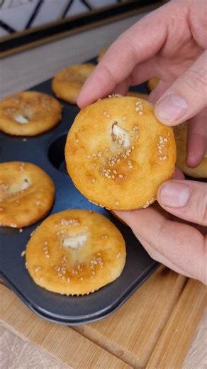 Only a Few Ingredients – Amazing Savory Muffins Recipe! Ingredients: 2 eggs 220 ml plain yogurt 100 ml vegetable oil 1 tsp salt 10 tbsp all-purpose flour 15 g baking powder Crumbled feta cheese (to sprinkle on top) Sesame seeds (to sprinkle on top) Instructions: In a bowl, whisk together the eggs, yogurt, vegetable oil and salt until smooth. Add the flour and baking powder, then mix well until you get a smooth, lump-free batter. Pour the batter into a greased baking tray (or lined with baking pa