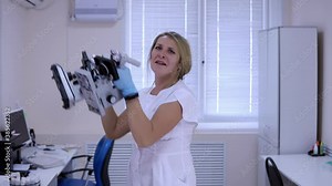 Cheerful doctor woman with microscopes in her hands dancing victory dance. Funny medical assistant in uniform clothing in laboratory having fun and fool around. It is evident that her hard but fun