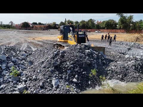 Large-Scale Land Reclamation Operation Bulldozer Pushing Stone Big Dumper Unloading Stone