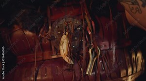 Feather curved from bone leather laces and vargan hand on shaman costume extreme close view. Tribal accessories of Altai folks. Culture conservation Stock Video