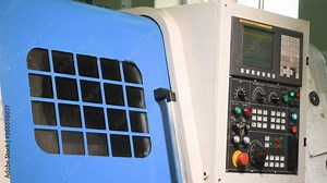 Factory plant worker employee engineer programming machine mechanism with computer control board tablet monitor pressing buttons, industrial equipment setup