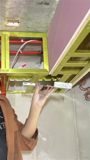 the process of installing a ceiling in a room by a builder