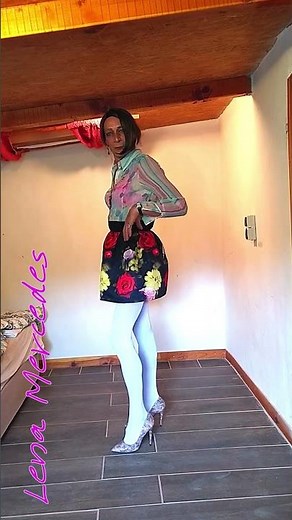 Crossdresser Lena in transparent blouse & short flowery skirt - stockings & heels top Crossdressing