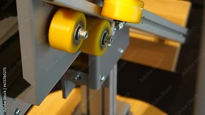 Product quality control machine - testing chair in factory. Closeup detail. Rollers and metallic parts moving in furniture manufacters plant. Slow motion.