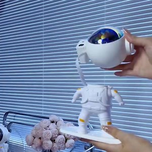 Bring magic into your room with this Astronaut Galaxy Projector Light! Enjoy stunning galaxy effects built-in speaker for relaxing music. Perfect for bedrooms, gaming rooms & décor lovers. | Souq
