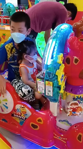 Enjoying a Giraffe Ride at the Indoor Arcade