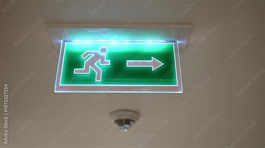 Arrow with running man indicates evacuation during emergency. Safety sign in hallway of hotel, residential building, or business center indicate effective exit. Emergency staircase indicator