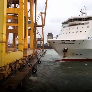 WATCH: A ferry had trouble docking during bad weather in Barcelona, toppling a crane and sparking a fire. | NBC News