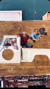 Step into a dynamic tableau frozen in time, brought to life through bold and expressive brushstrokes in this captivating oil painting. Three men, perched on the back of a pickup truck, compose a scene reminiscent of an old-time film set. The driver’s steady grip on the wheel, the man filming with an antique camera, and the relaxed cigar-smoker encapsulate an era of camaraderie and adventure. Each stroke amplifies the sense of movement, evoking curiosity about their story. This figurative masterp