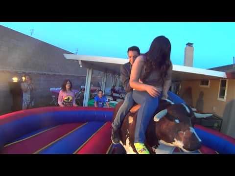 Boy and girl riding Mechanical bull