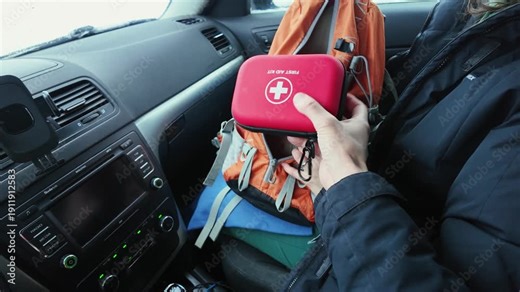 Driver Pulls Red First Aid Kit From Backpack On Passenger Seat Quick Sequence Of Hands Taking Pouch, Checking Zipper, Preparing Pouch For Stowage In Console, Tense But Controlled Mood, Snowy Daylight