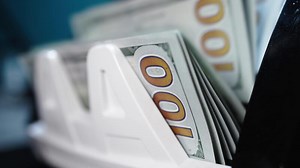 Download Currency exchange of one hundred dollar banknotes. Machine counting money. Macro shot cash counting machine calculating 100 dollar bills for free