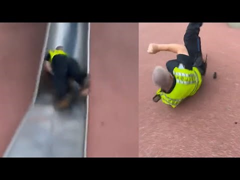 Police Officer Tumbles Down Giant Playground Slide