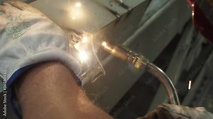 worker welding steel with mig welder machine slow motion