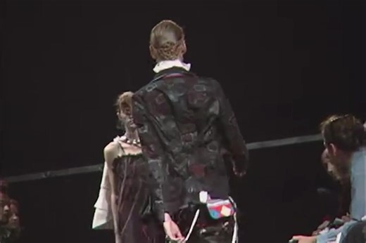 Undercover’s Spring/Summer 2003 “SCAB” was Jun Takahashi’s first Paris Fashion Week show, and it instantly became known as his masterpiece. The collection was built around a “crust punk” aesthetic — clothes that looked lived-in, torn, repaired, and repaired again. Patchwork jackets, reconstructed pants, and bags covered in stitched fabric pieces were made to resemble healing skin, giving the outfits a raw, handmade feel. The runway had a tense, rebellious atmosphere, showing Takahashi’s mix of p