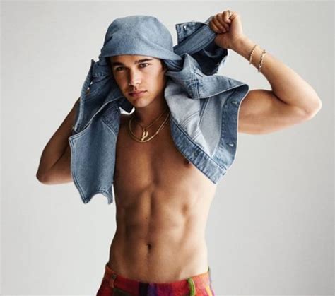 A Shirtless Man With No Shirt On Wearing Shorts And A Denim Jacket Over His Head