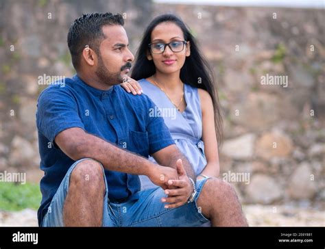 Lovely Sri Lankan Couple Sitting In Front Of Galle Fort Husband Staring At Far While Wife