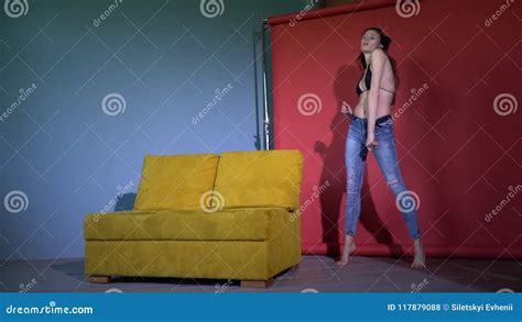 A Slim Model Stands Near The Couch And Slowly Undresses Slow Motion Stock Footage Video Of