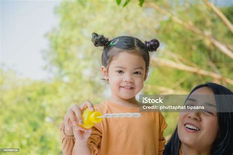 Asian Mom And Daughter Blowing Bubble In Parkconcept Portrait Lifestyle Asian Beautiful Mother