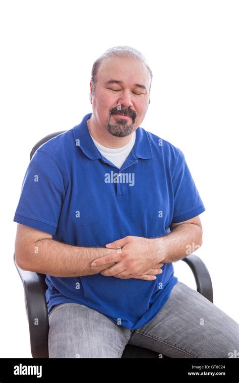 Close Up Thoughtful Adult Man In Blue Polo Shirt Sitting On A Chair With Eyes Closed And