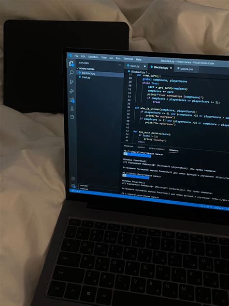 An Open Laptop Computer Sitting On Top Of A Bed Next To A White Comforter