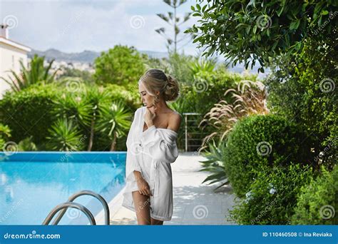 Beautiful Sexy Sensual And Hot Blonde Model Girl In Peignoir Posing Half Naked Near Swimming