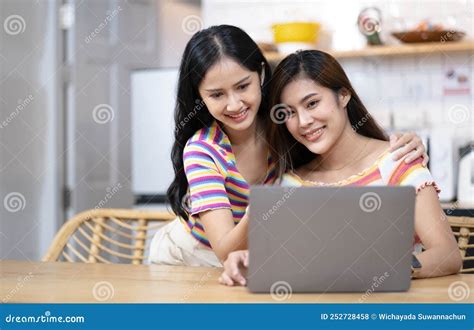 Two Female Lgbt Lesbian Couple Best Girlfriends Hugging Watching Movie On Laptop Together Stock