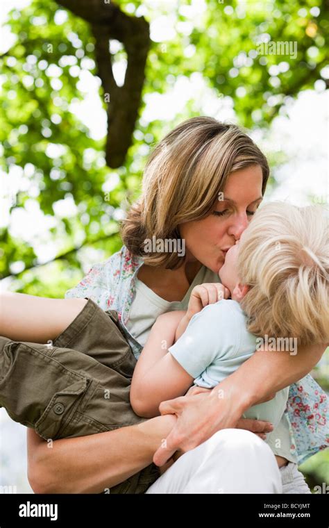 Mother Kissing Son Stock Photo Alamy