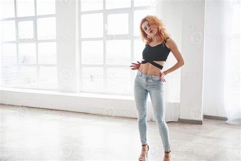 Leisure Activity Attractive Redhead Woman Posing In The Spacey Room Near The Window 8682285