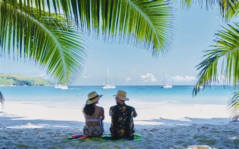Praslin Seychelles Tropical Island With Withe Beaches And Palm Trees Couple Men And Women Mid