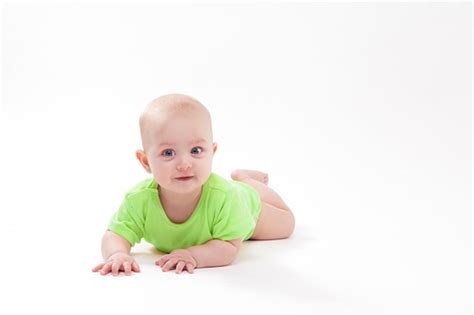 Premium Photo Smiling Baby Lying On His Stomach And Looking