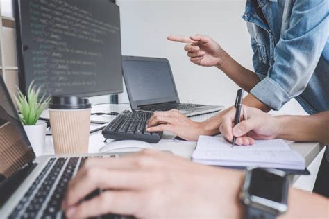 programmers cooperating at developing programming and website working in a software develop