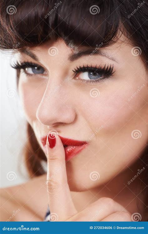 Lets Keep This Between Uscropped View Of A Sultry Woman With Her Finger To Her Lips Stock