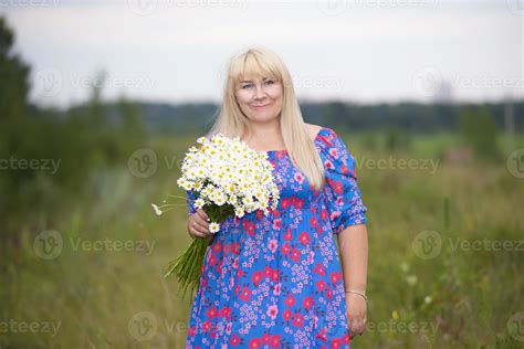 Beautiful Plus Size Woman With White Hair In A Summer Dress Posing Outdoors With Daisies Chubby