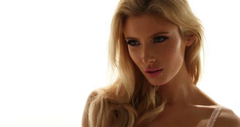 Smiling Pretty Woman With Long Blond Hair Posing In Sexy Pink Lingerie While Looking At The