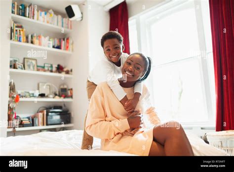Portrait Affectionate Mother And Son Hugging On Bed Stock Photo Alamy