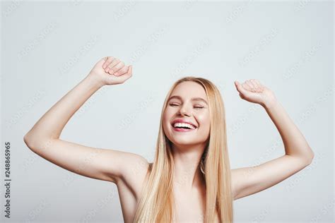 Yes I Did It Happy Young Blonde Woman With Naked Shoulders Smiling With Raised Hands While