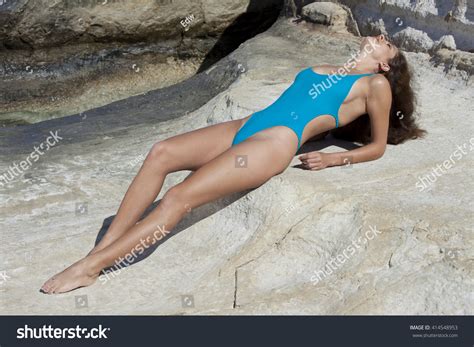 Woman Sunbathing On Rocks Wearing Tight Stock Photo 414548953
