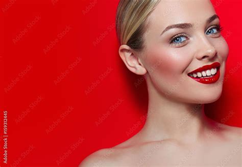 Beautiful Young Well Groomed Girl With Blond Hair On A Red Background Woman Smiling Blonde