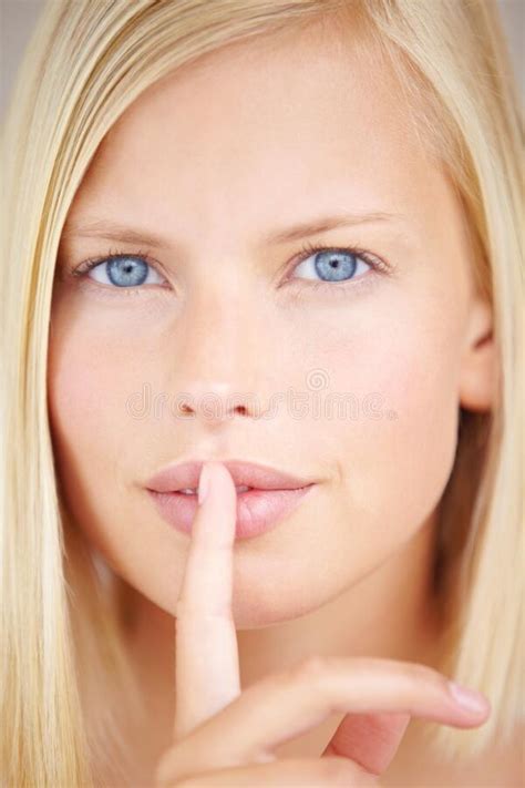 No Words Needed Portrait Of A Young Woman Holding Her Finger In Front Of Her Lips Stock Image