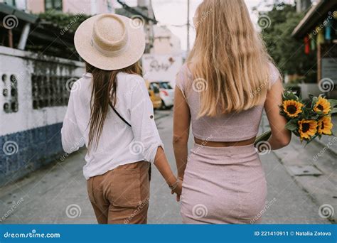 Two Lesbians Walking Down The Street Holding Hands Stock Image Image Of Back Hands 221410911