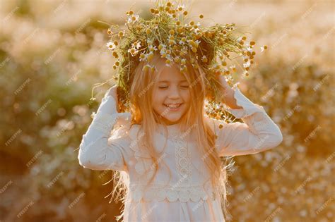 Premium Photo Portrait Of A Little Blonde Girl With A Wreath Of Daisies On Her Head In The