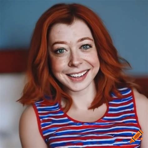 Alyson Hannigan In A Powder Blue Hotel Room Wearing A Red And Blue Striped Sleeveless Sweater
