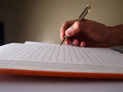 Hand Holding A Pen And Writing On A Notebook Stock Image Image Of